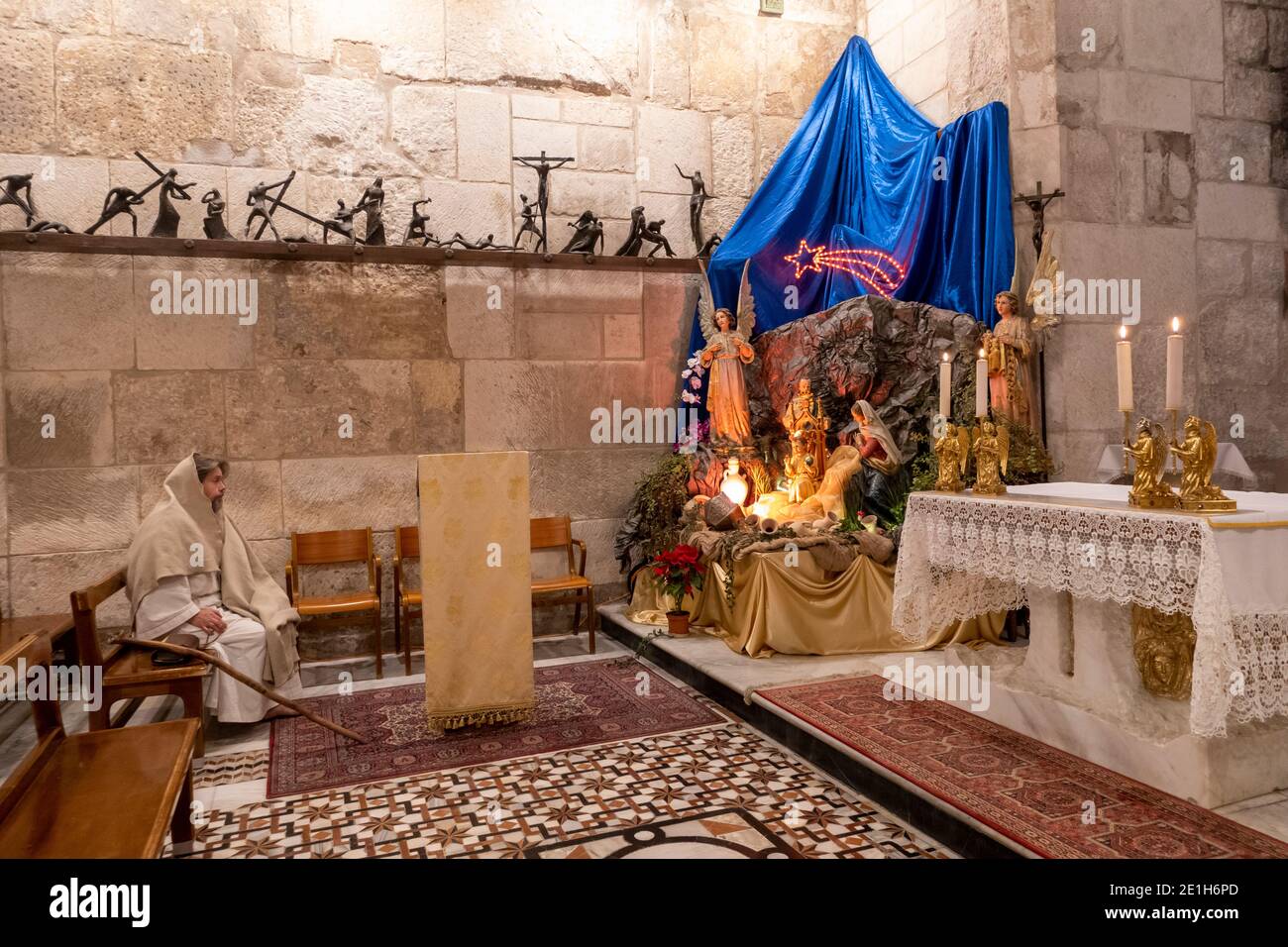 A Christian worshiper dressed as Jesus Christ sits in front of a ...
