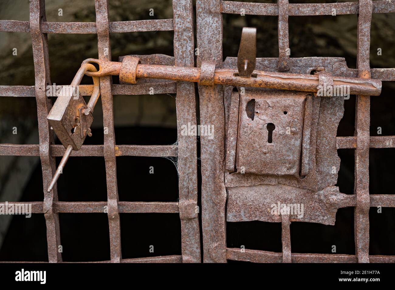 Close-up detail of a rusted antique padlock ang gate lock and grille ...