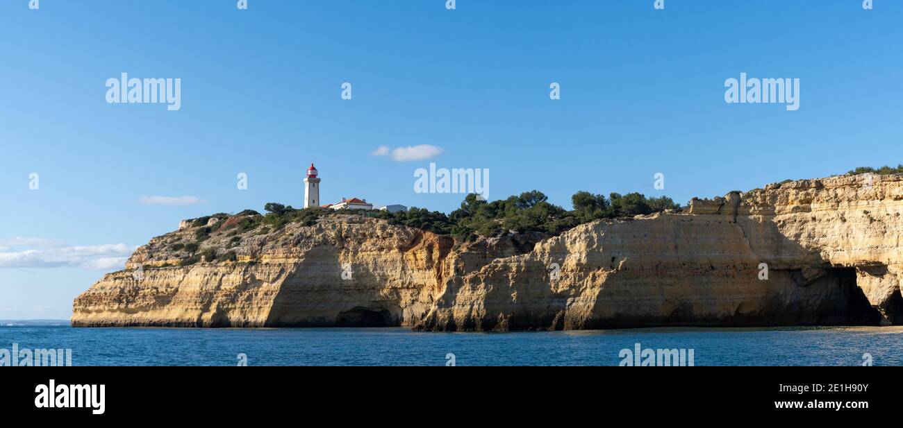 A view of the Alfanzina lighthouse on the beautiful Algarve coast of ...
