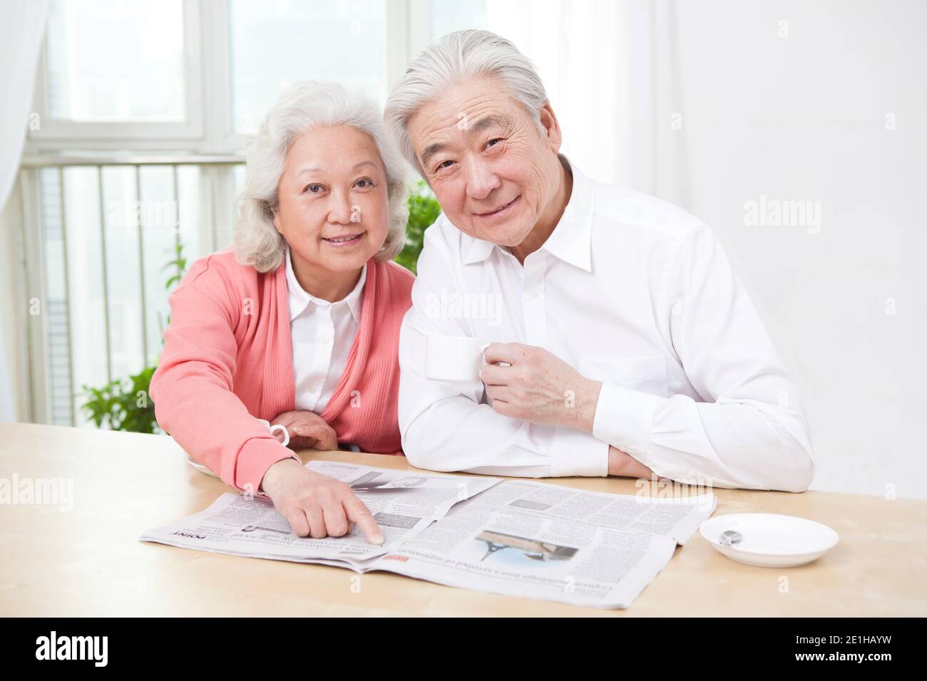 The happy old couple are reading the newspaper high quality photo Stock ...
