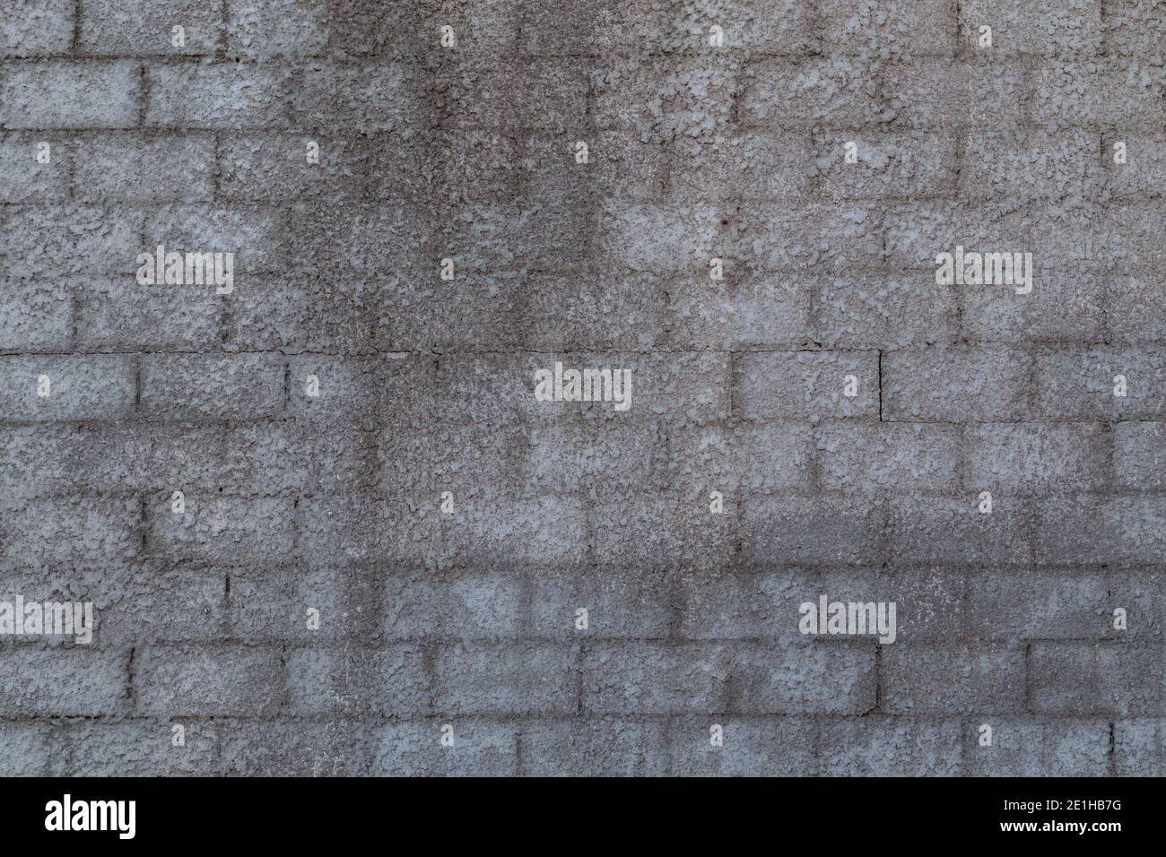 wall of cinder blocks covered with a layer of shagreen concrete plaster ...