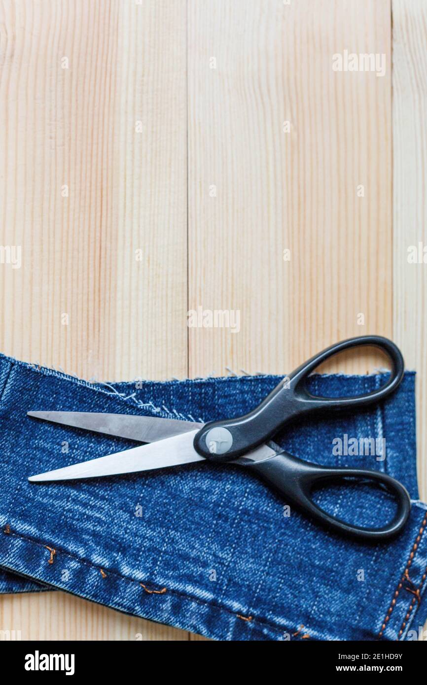 Scissors and two narrow strips of denim on light background Stock Photo ...