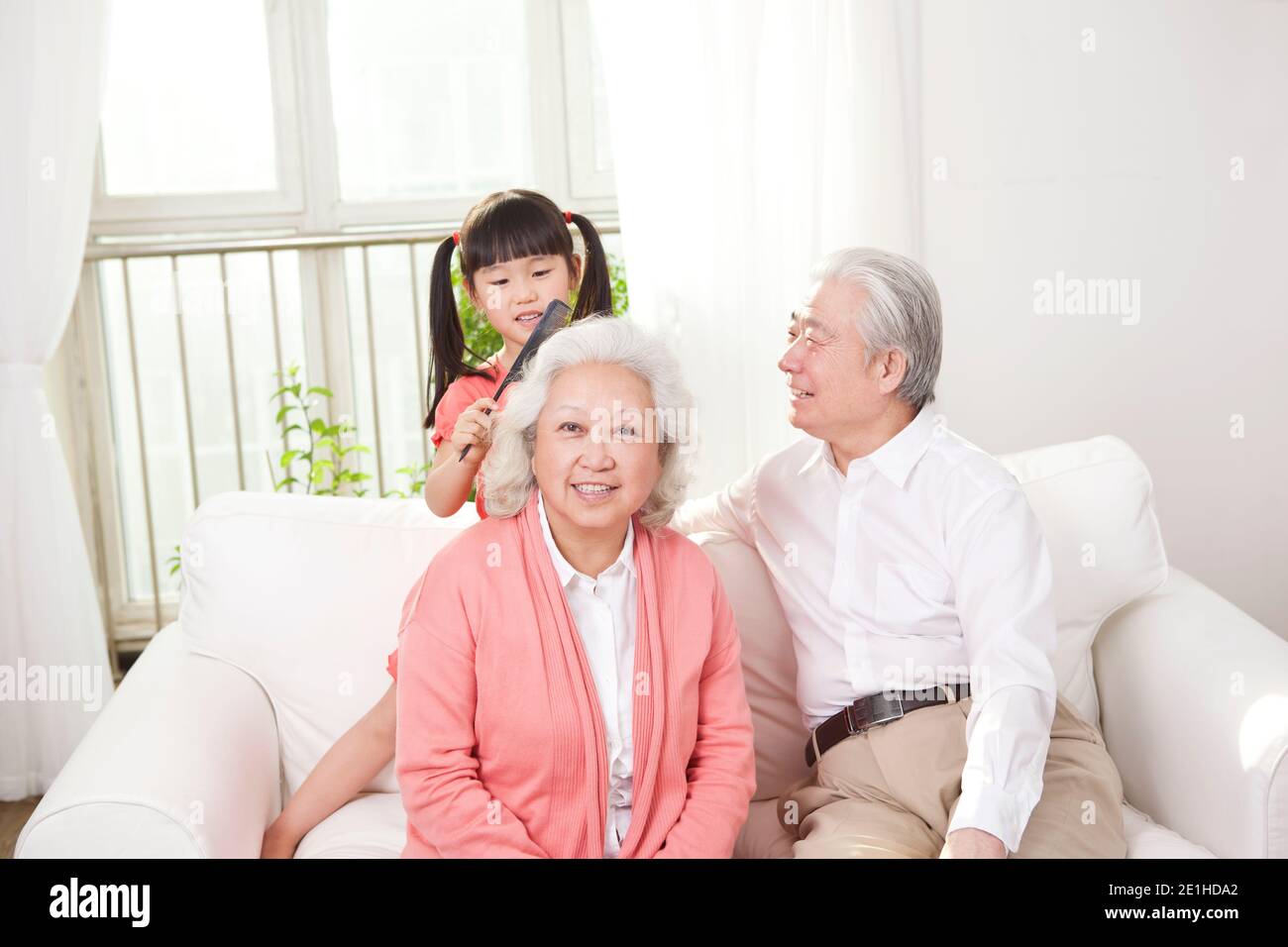 Happy grandparents and grandchildren are playing in the living room ...