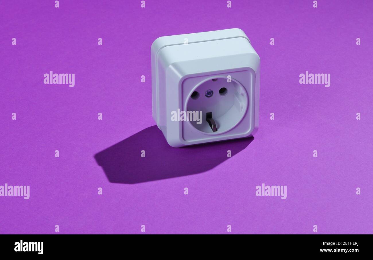 White plastic power socket on purple background. Minimalism Stock Photo ...