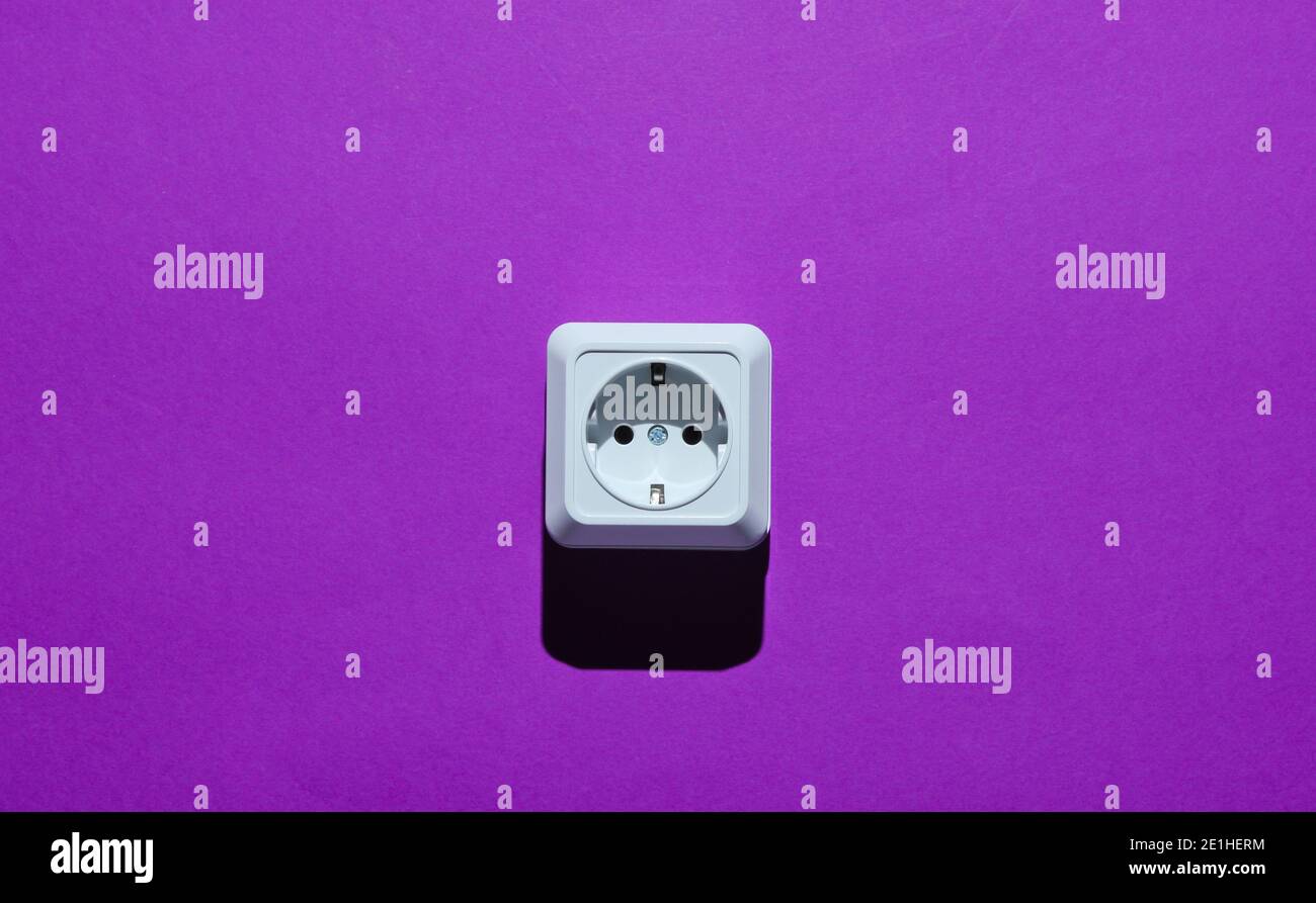 White plastic power socket on purple background. Minimalism Stock Photo ...