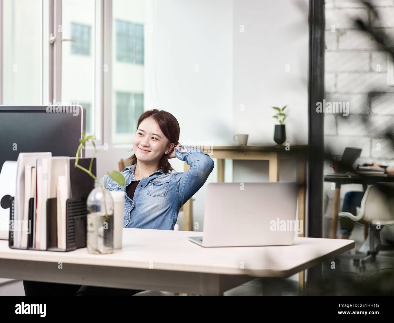 young asian business woman working in office using desktop computer ...