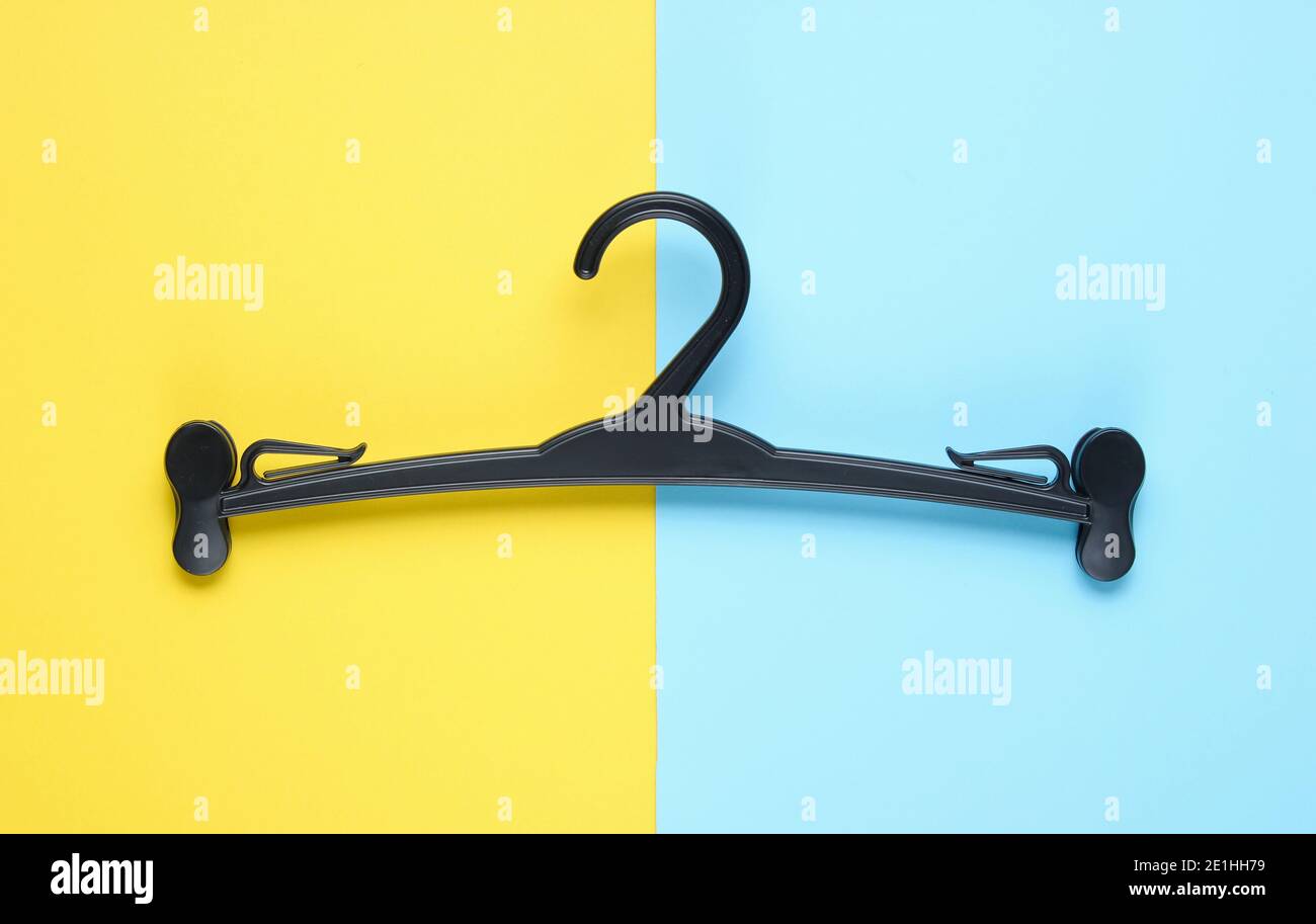 Plastic hanger on a pastel background. Top view Stock Photo - Alamy