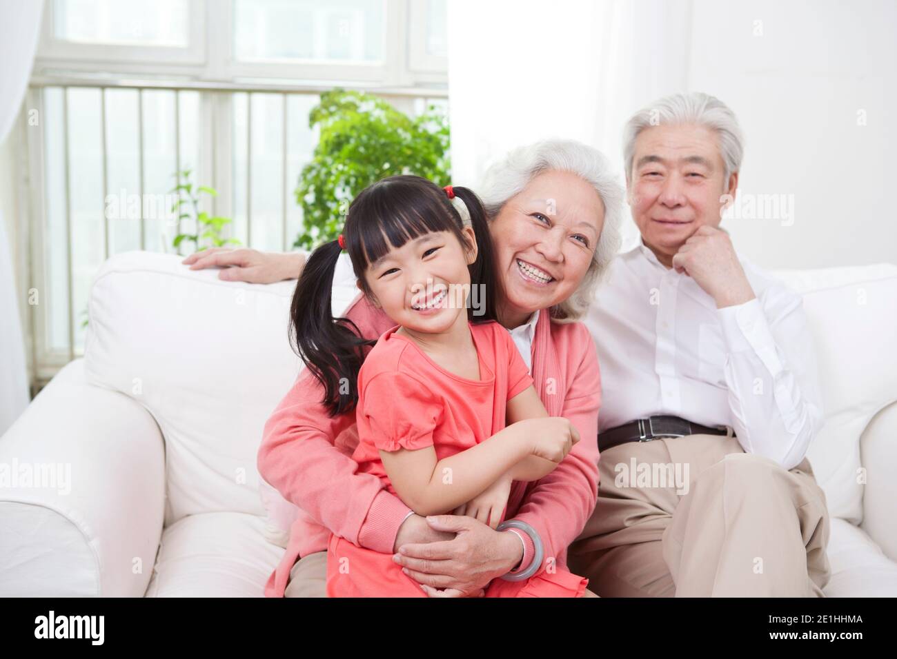 Happy grandparents and grandchildren are playing in the living room ...