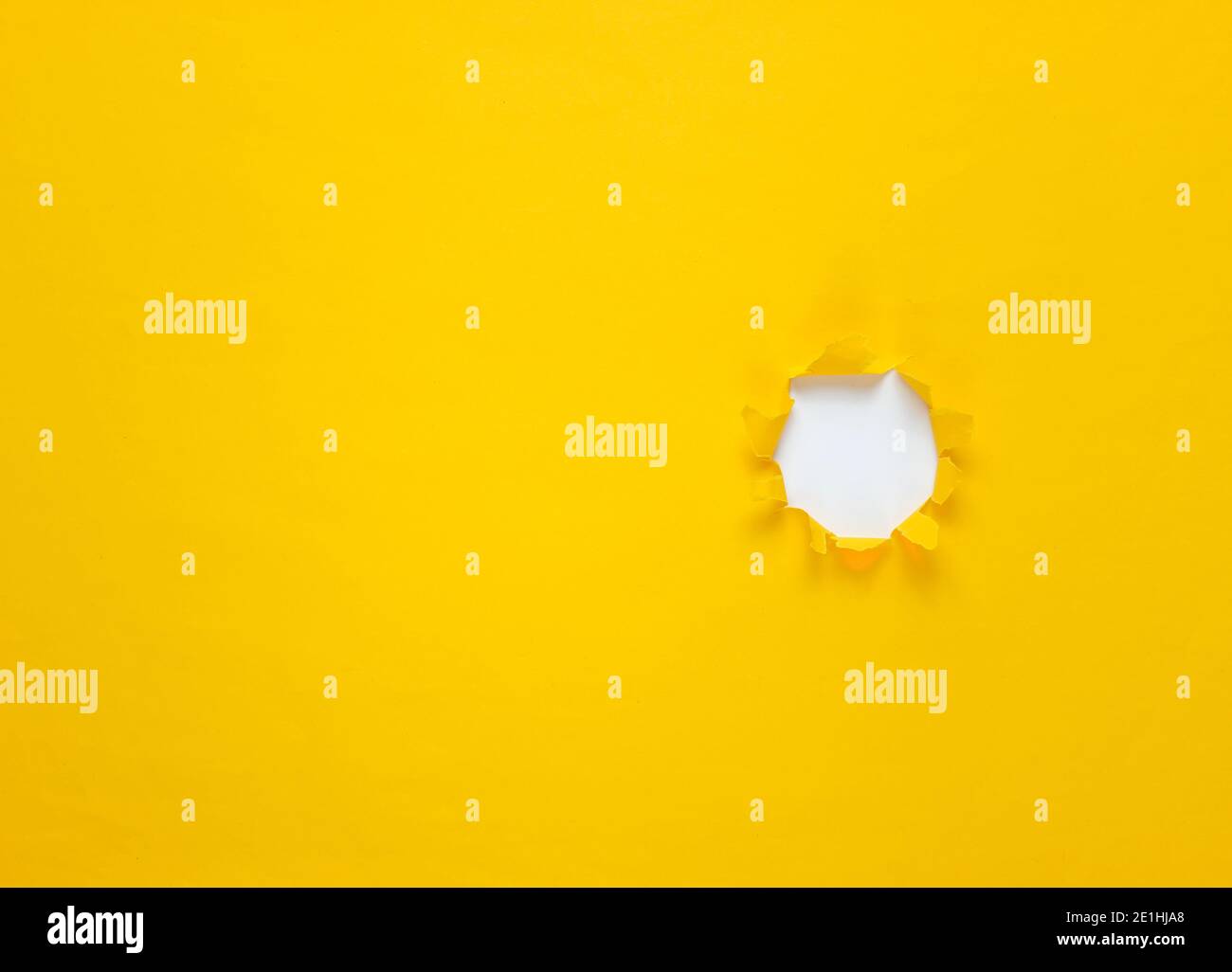 Torn hole in yellow paper. Top view. Minimalistic business concept ...
