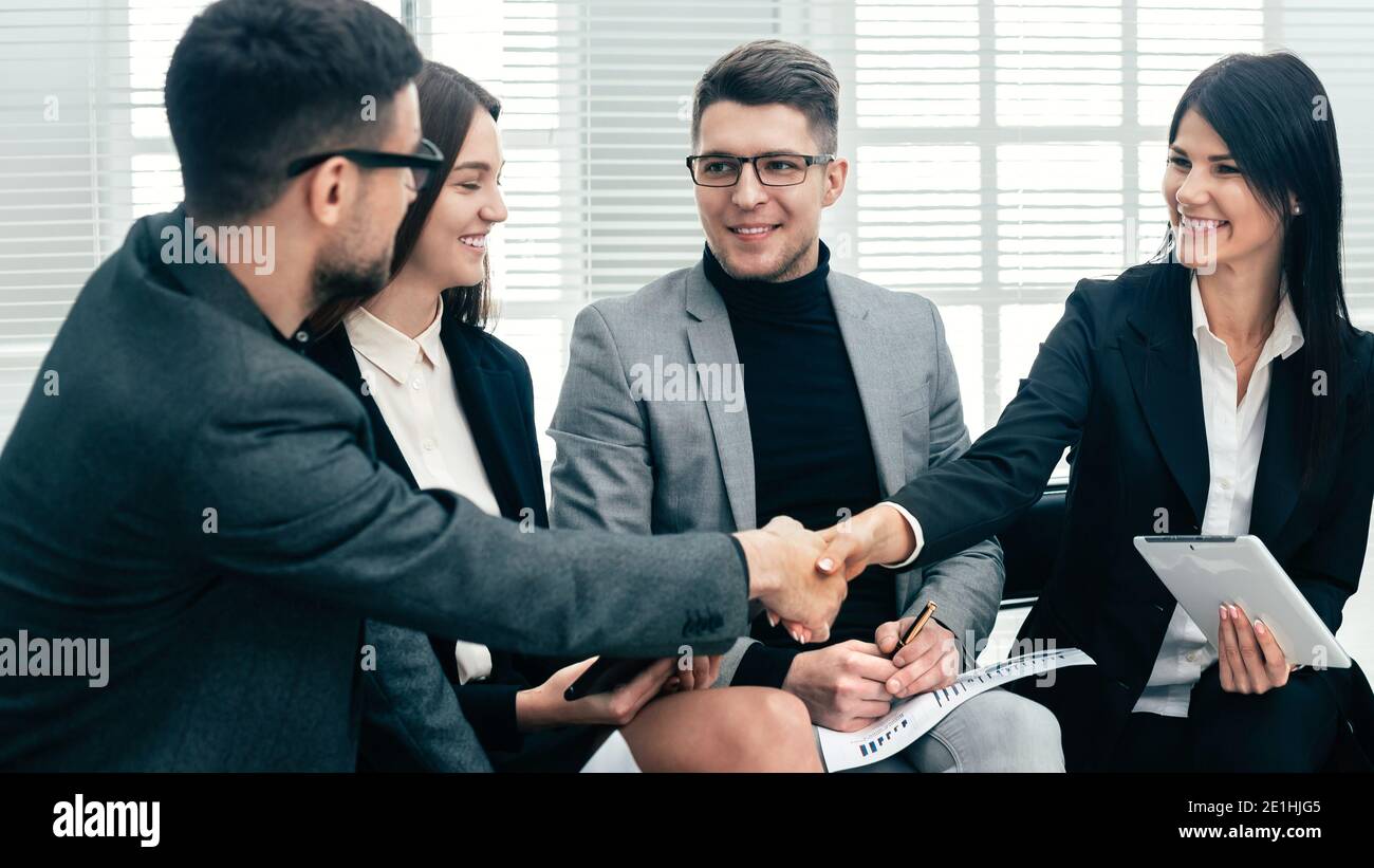 business colleagues greet each other at an office meeting Stock Photo ...