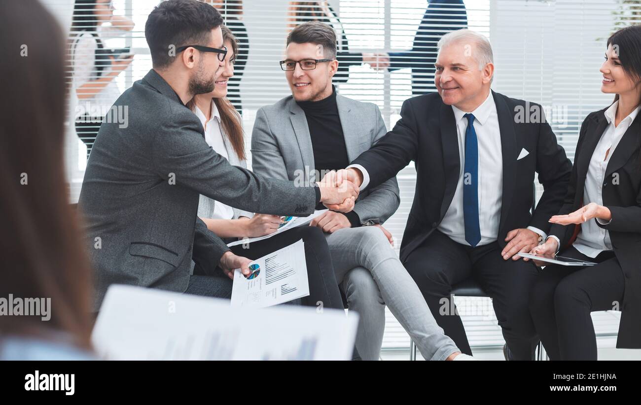 business partners shaking hands at a work meeting Stock Photo - Alamy