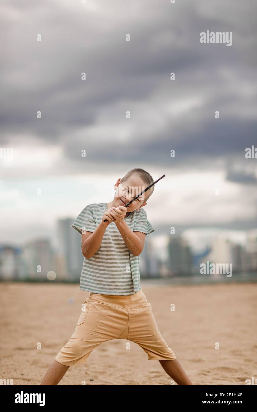 Outdoor portrait of a little cute boy with stick Stock Photo - Alamy