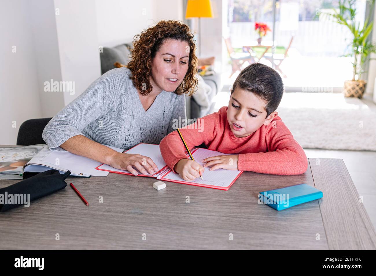 Mother helping his son to do homework Stock Photo - Alamy