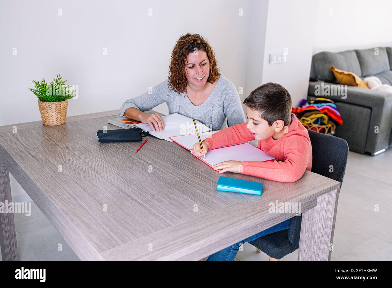 Mother helping his son to do homework Stock Photo - Alamy