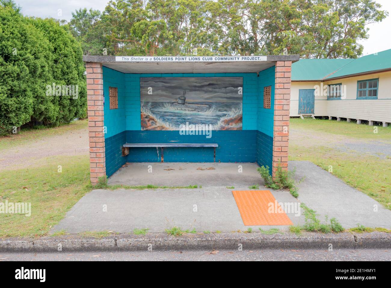 A blonde brick and ash concrete bus shelter built by the Lions Club at ...