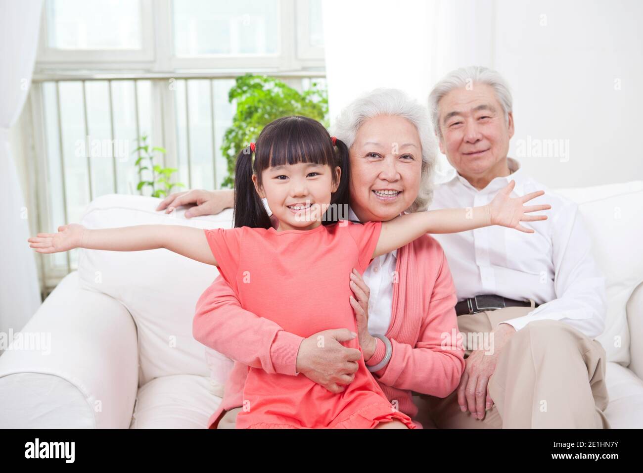 Happy grandparents and grandchildren are playing in the living room ...