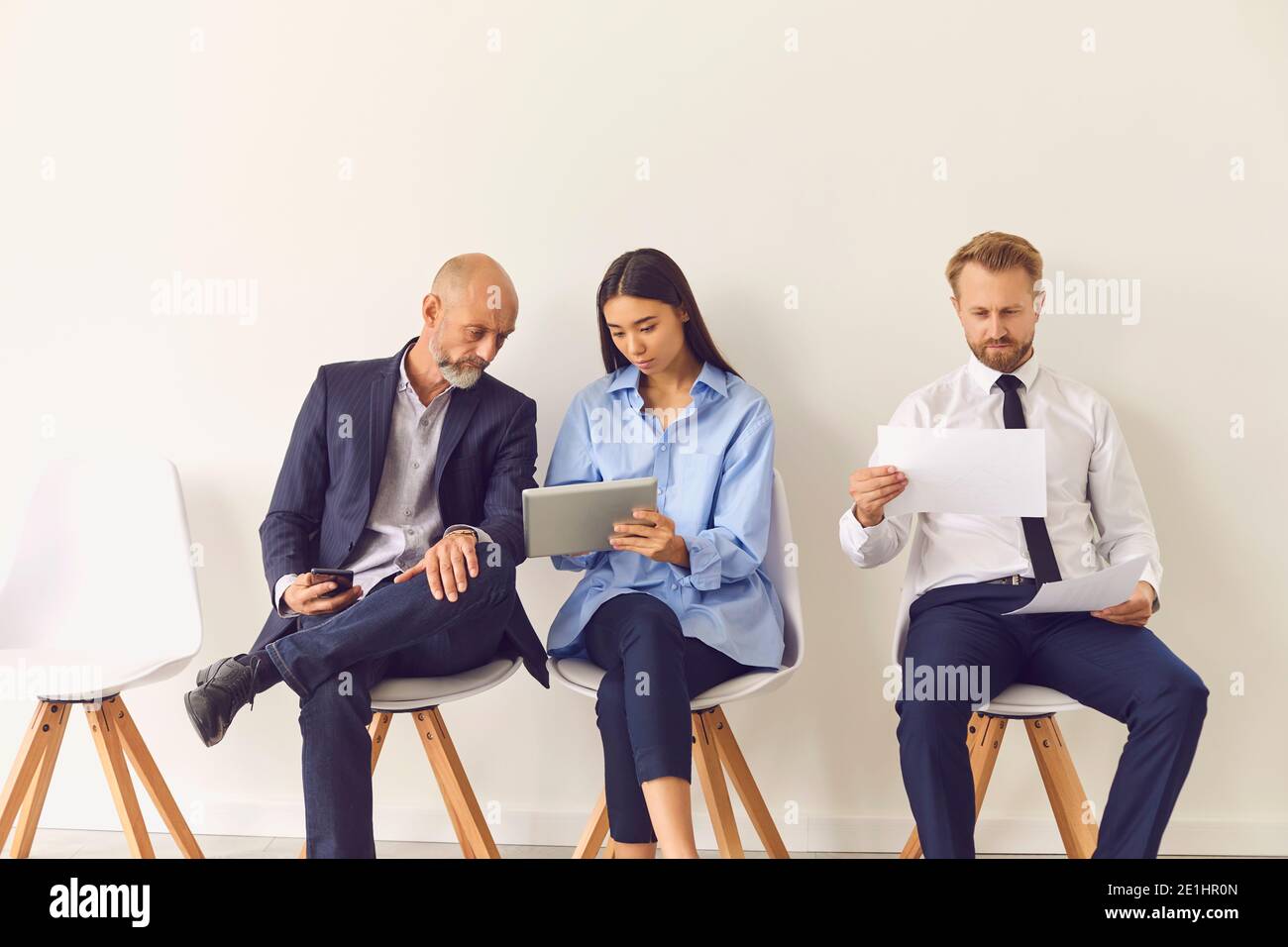Three successful employees of different ages and articles are preparing ...