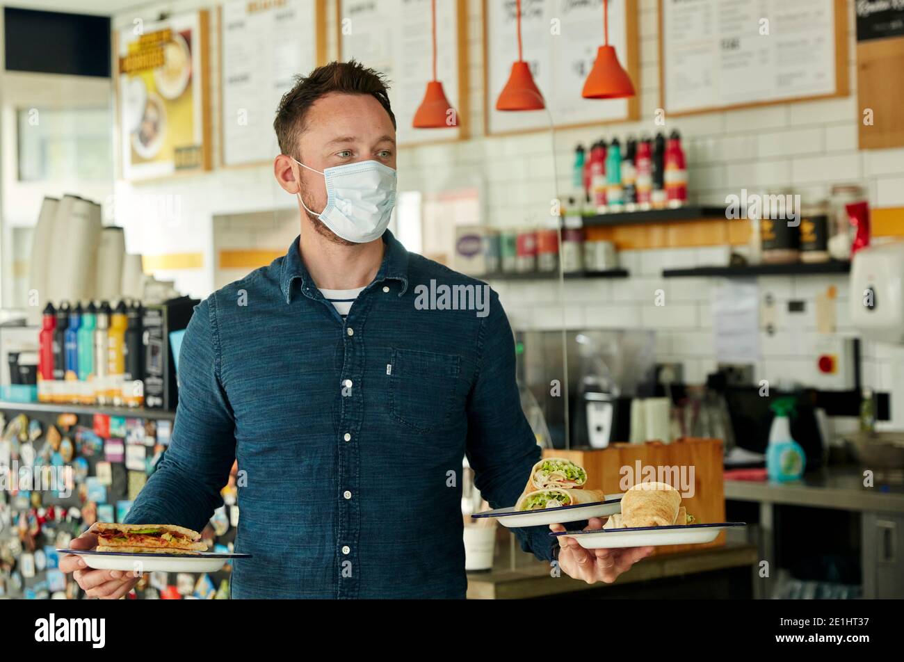Male waiter carrying plates hi-res stock photography and images - Alamy