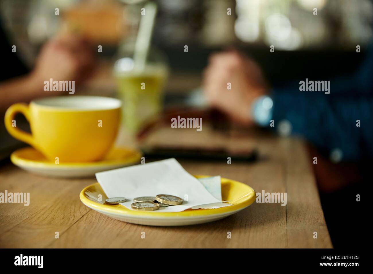 Coins and bill on cafe table Stock Photo - Alamy