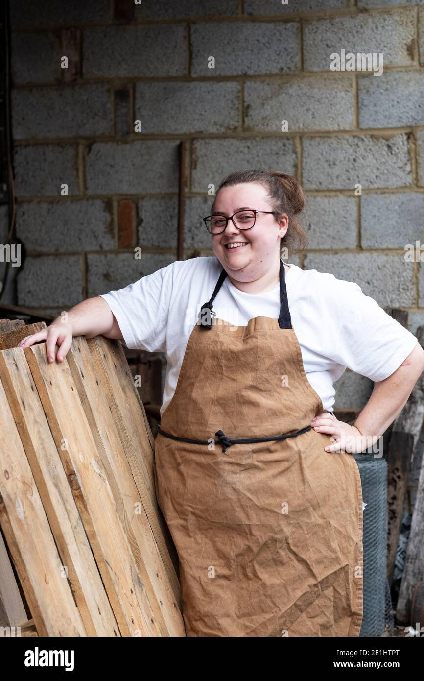 Portrait of female baker outdoors, hand on hip, smiling at camera Stock ...