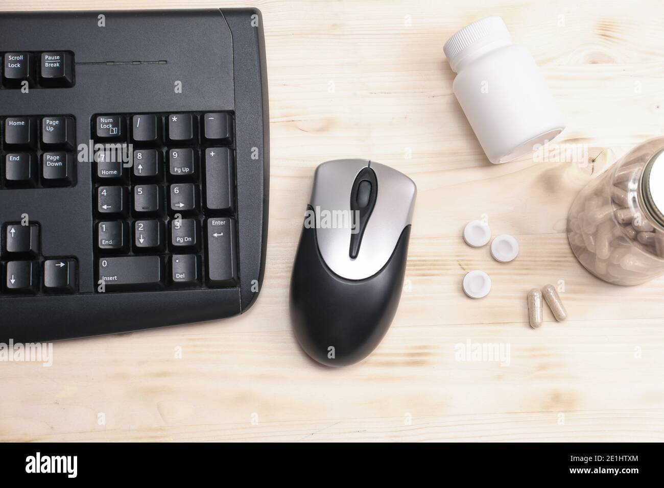 computer keyboard, mouse and bottles of mental support supplement ...