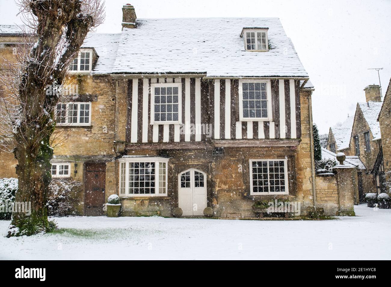 Stone and timber framed house in the December snow. Sheep street ...