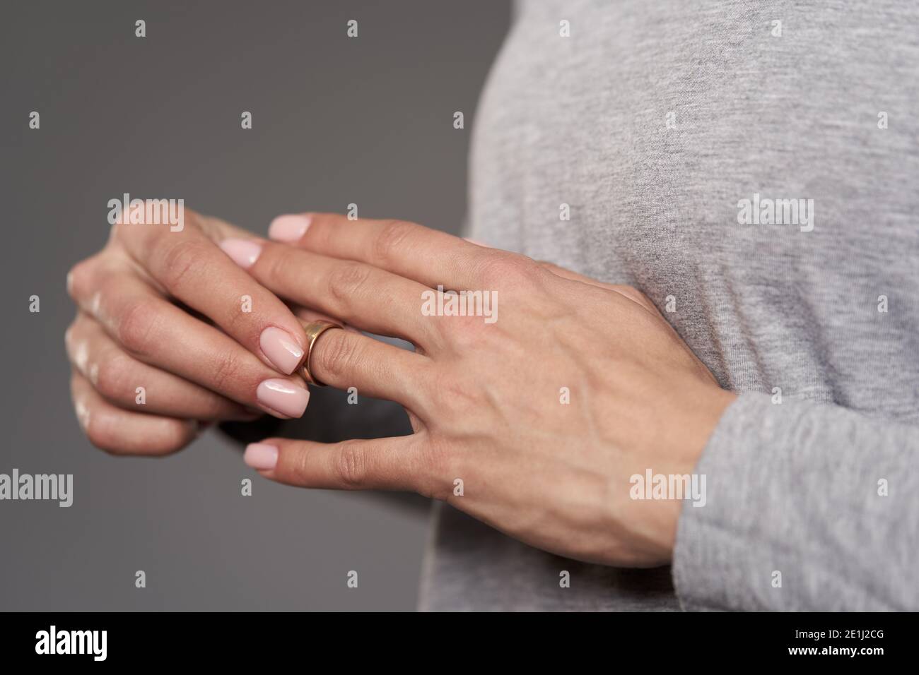 Woman taking off wedding ring hi-res stock photography and images - Alamy