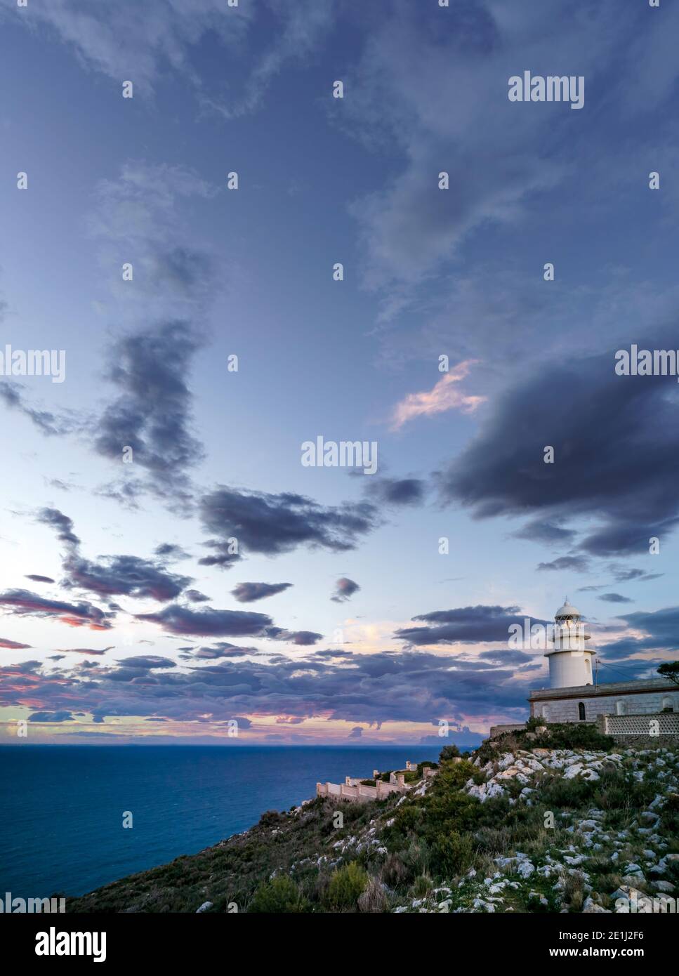 Lighthouse on top of the cliff near the ocean at dusk Stock Photo - Alamy