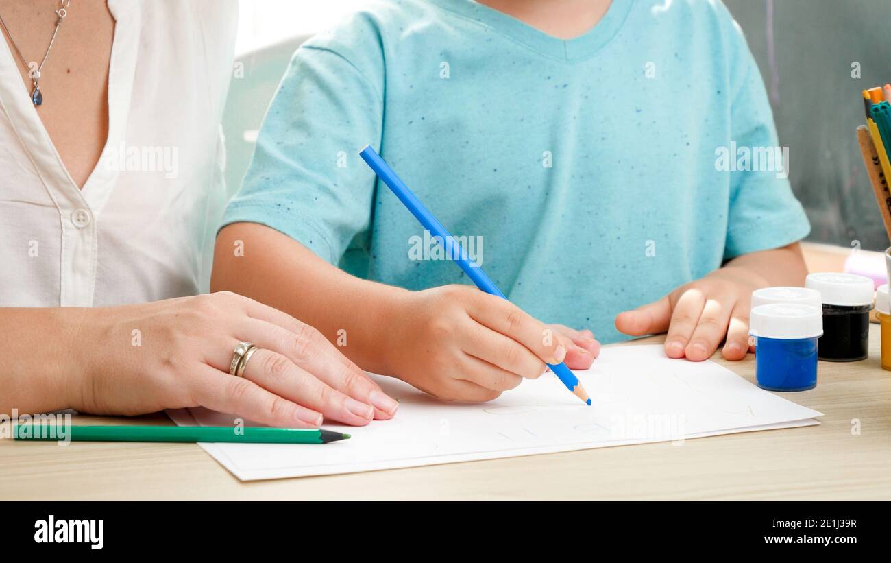 Closeup video of teacher teaching drawing and painting little boy with ...