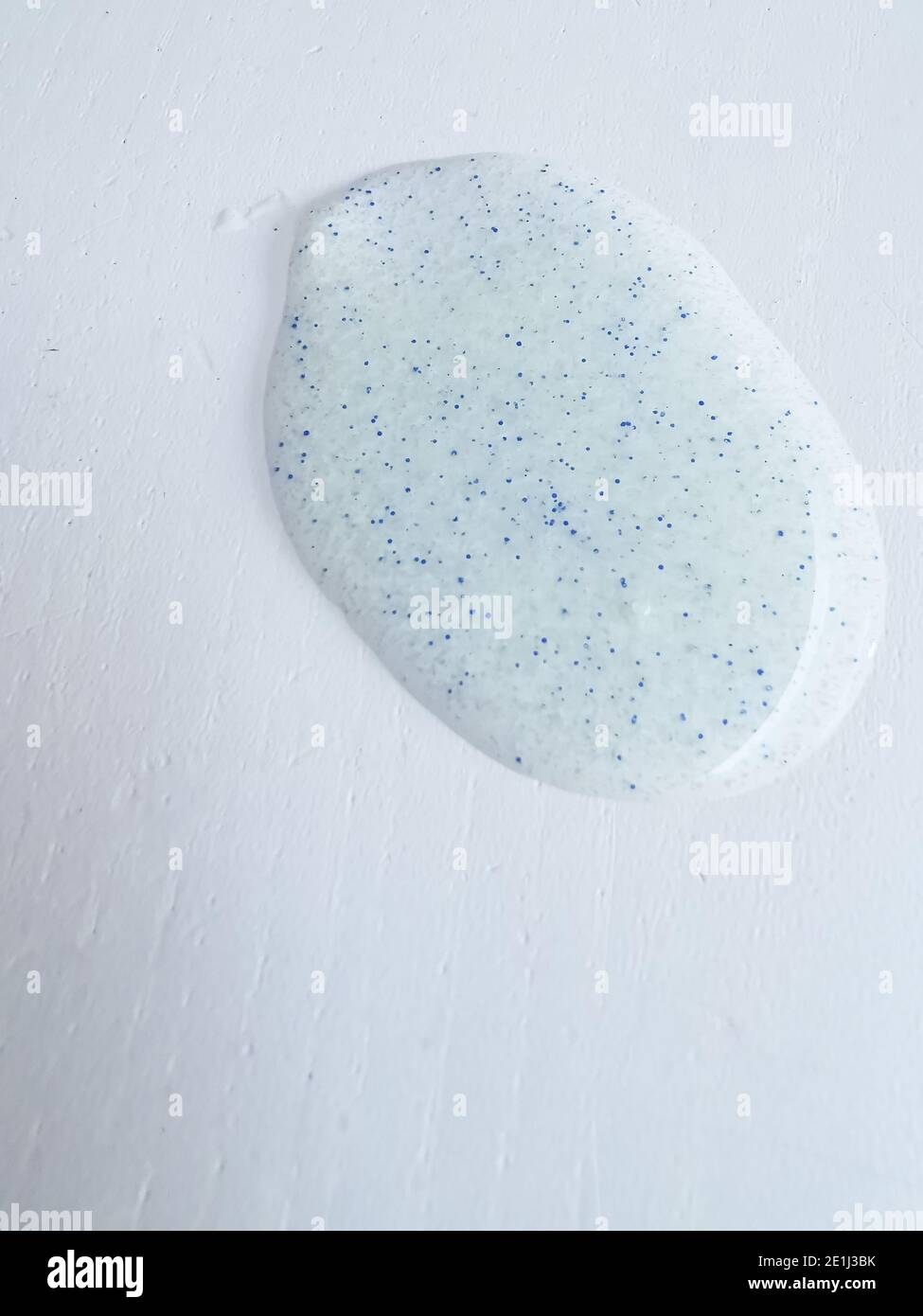 Micro plastic particles in a face scrub on a white background ...