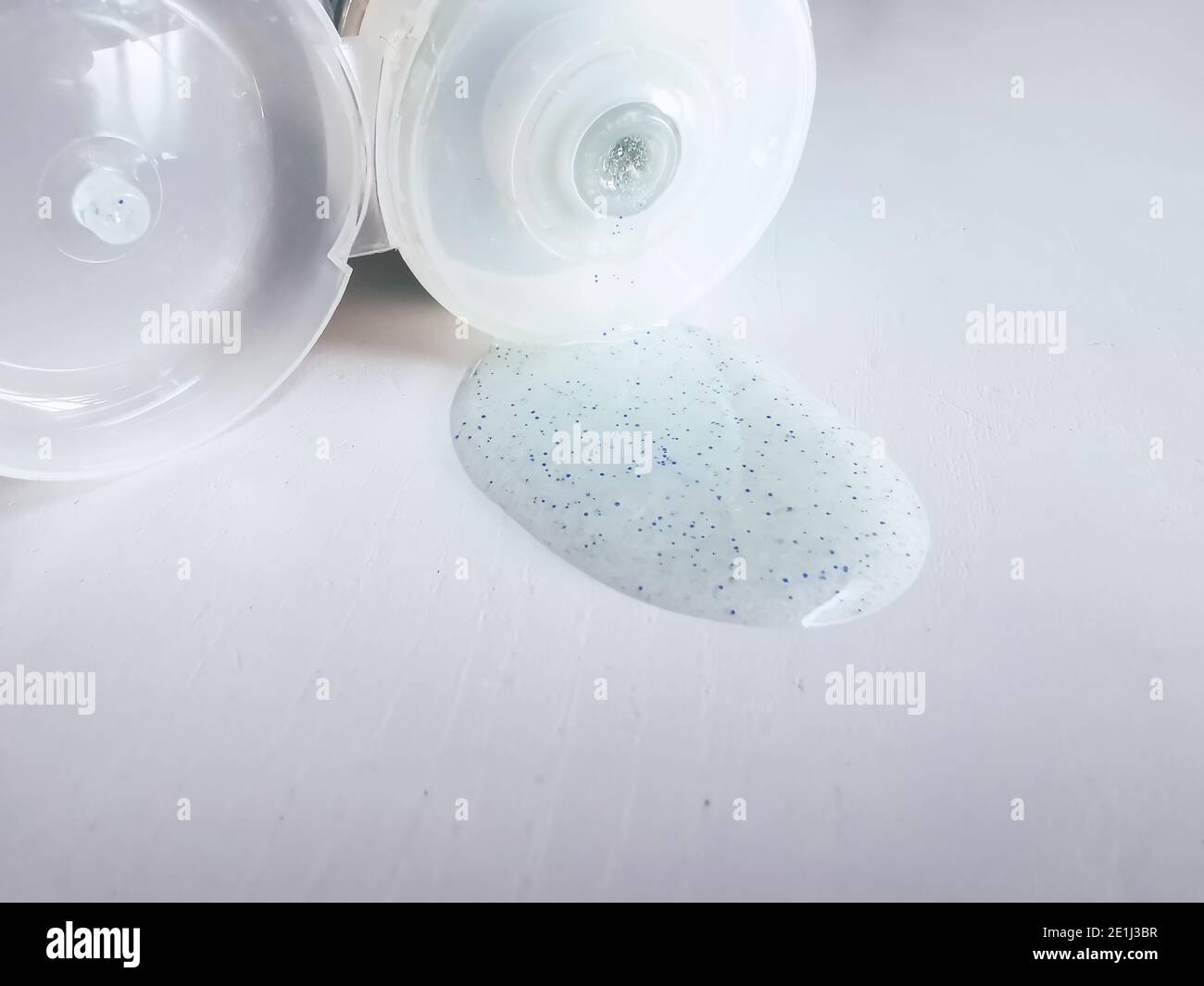 Micro plastic particles in a face scrub on a white background ...
