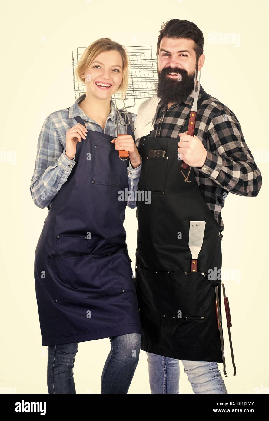 Tools for roasting meat. Couple in love hold kitchen utensils. Man ...
