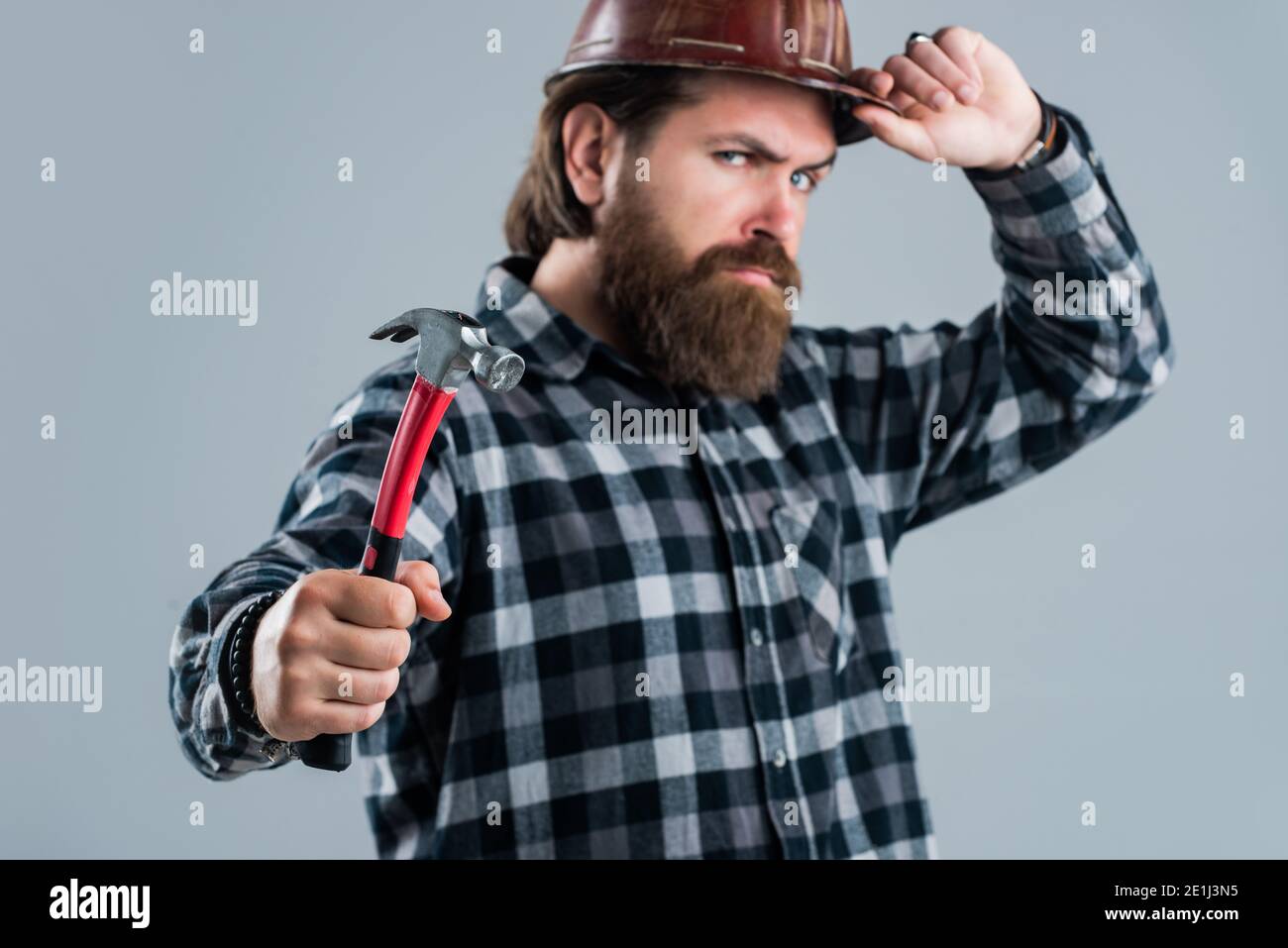 brutal bearded man worker in helmet. mature guy builder with beard and ...