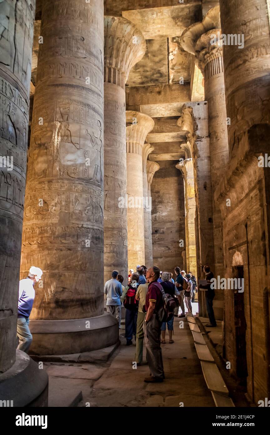Edfu. Tourists gaze at some of the mighty finely carved columns in the ...