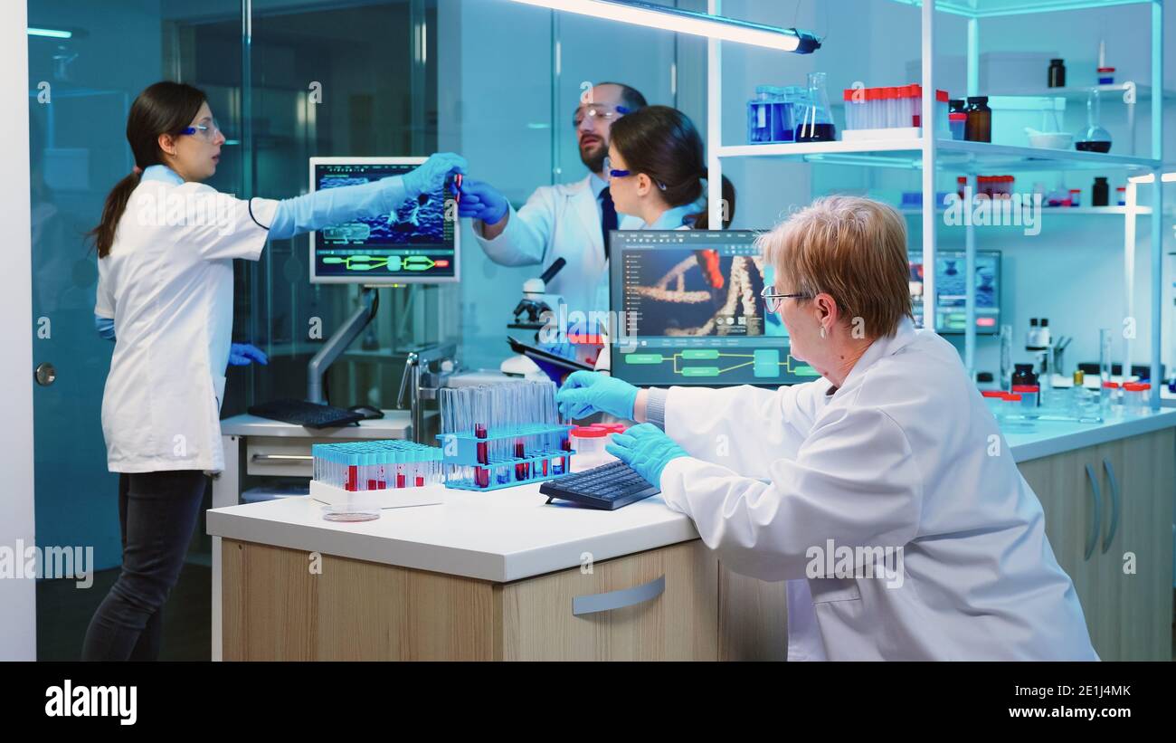 Nurse holding tablet computer with scientific informations while ...