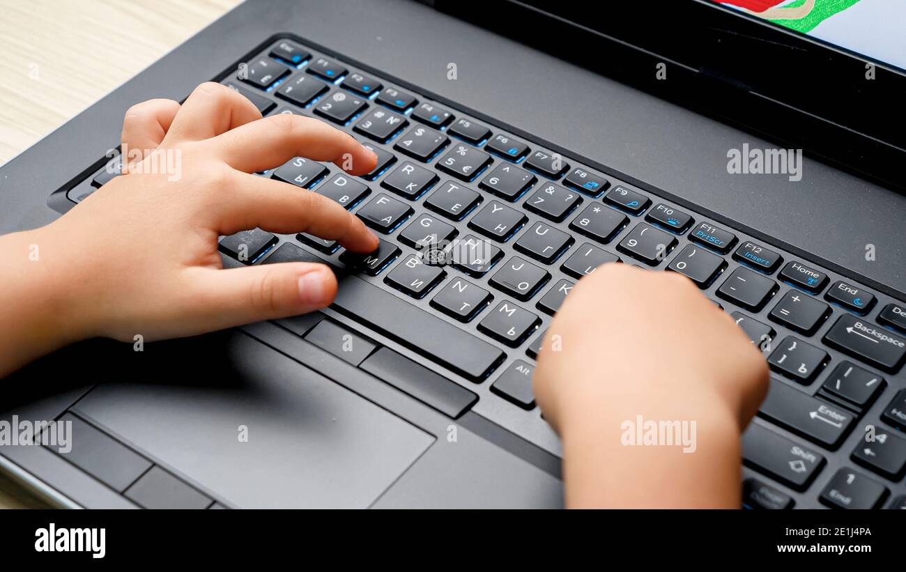 Closeup video of small child hand and finger pressing buttons on laptop ...