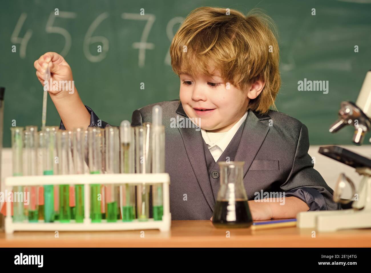 Little kid learning chemistry in school laboratory. Little boy at ...