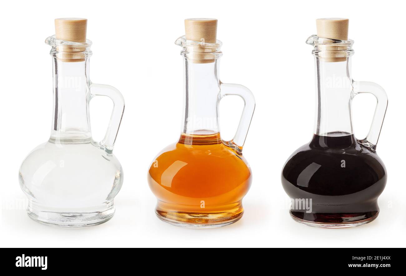 White, apple cider and balsamic vinegar in glass bottles isolated on ...