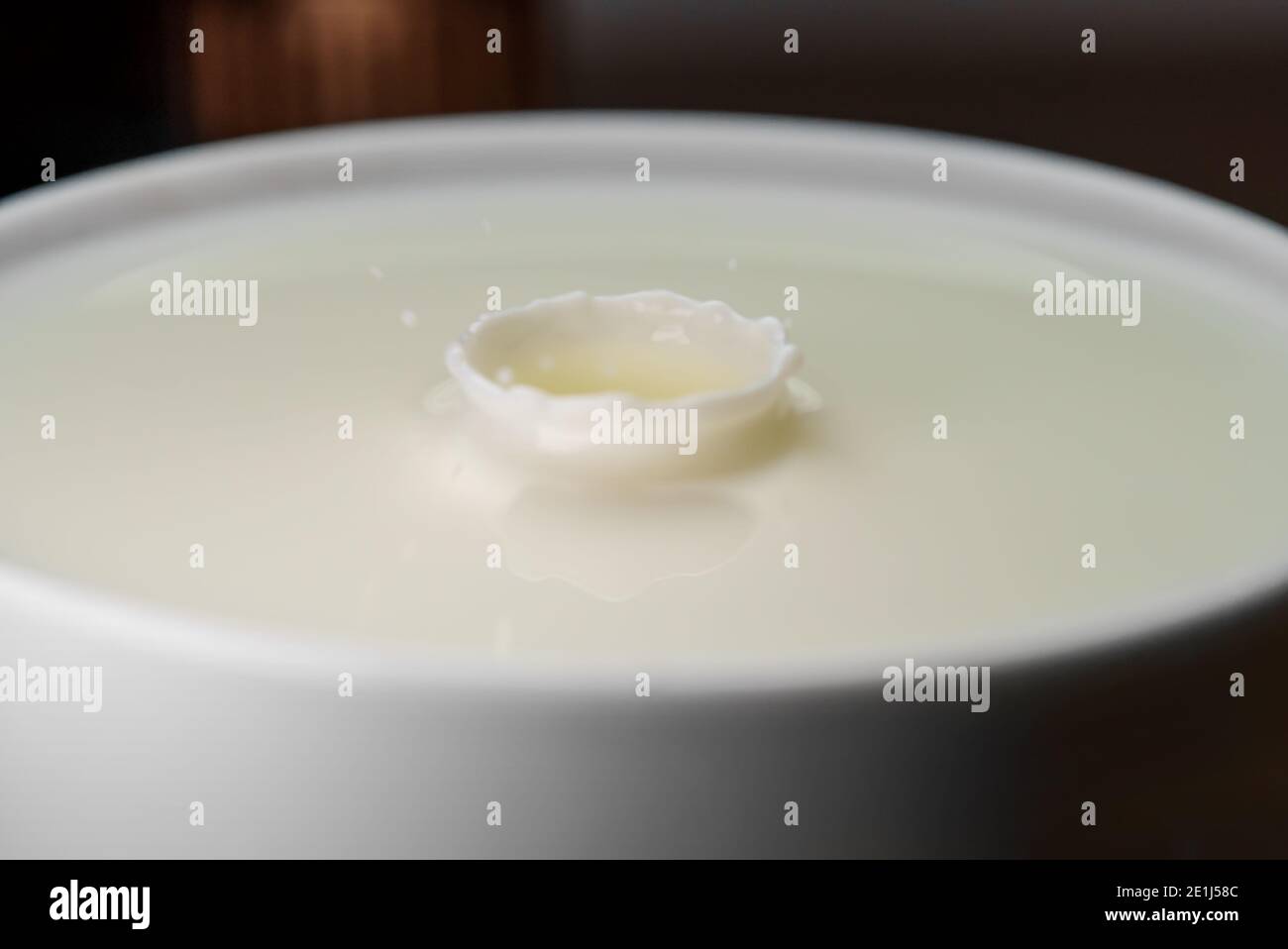 Milk drop falls filled cup hi-res stock photography and images - Alamy
