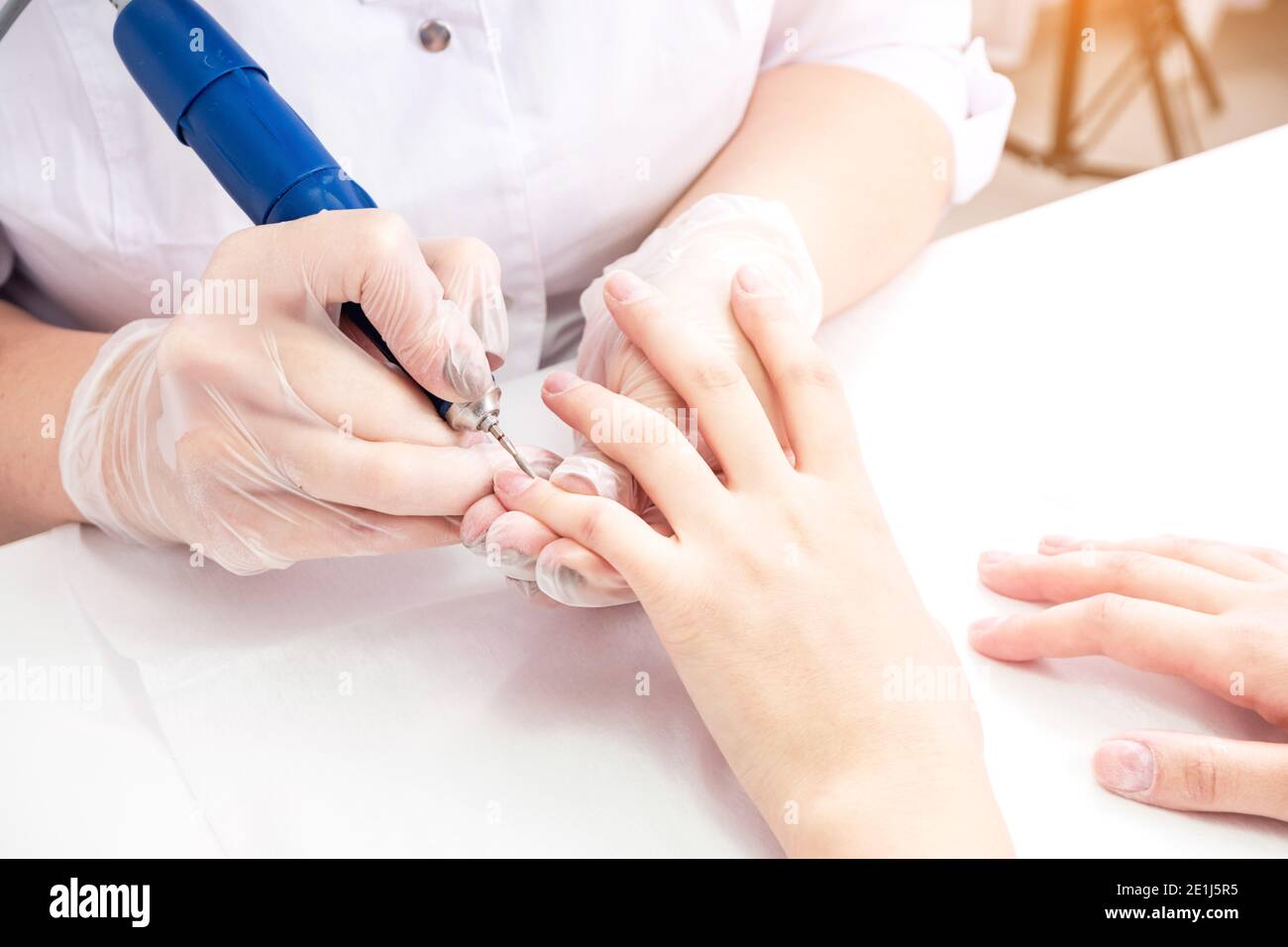 Professional manicurist coating nail plate hi-res stock photography and ...