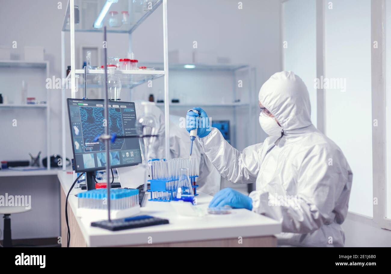 Lab scientist uses micropipette while examining sample doing drug ...