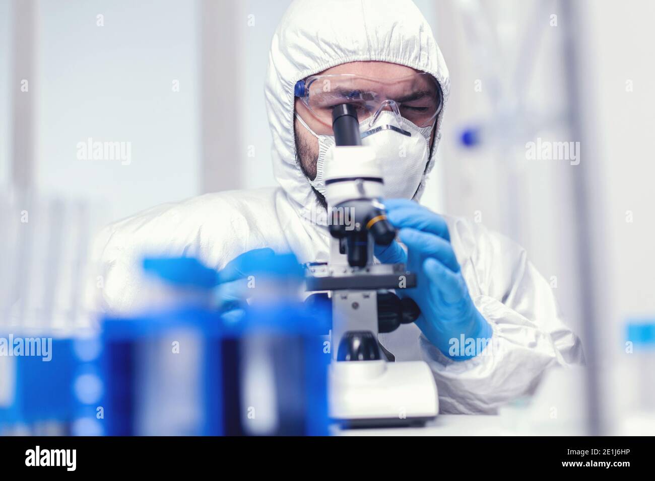 Microbiologist researcher wearing ppe and protection glasses in ...