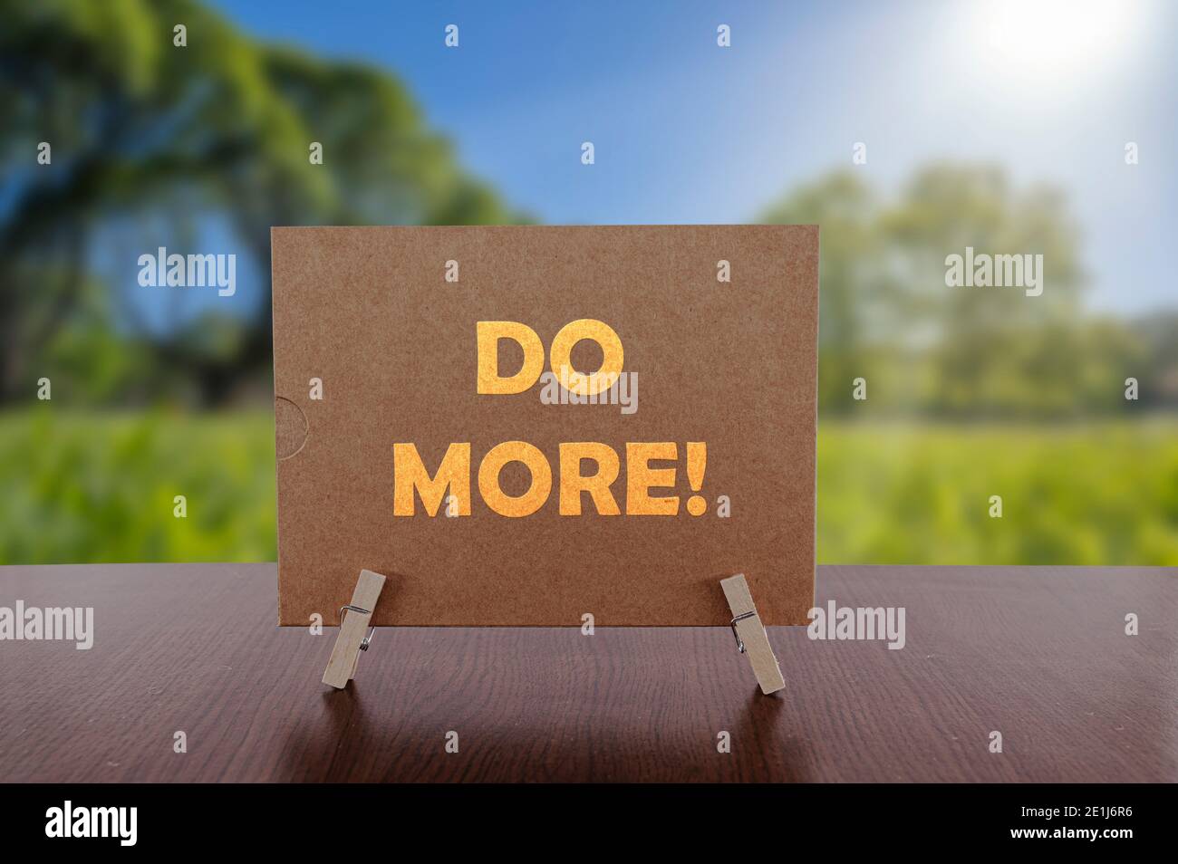 Do more text on card on the table with sunny green park background ...