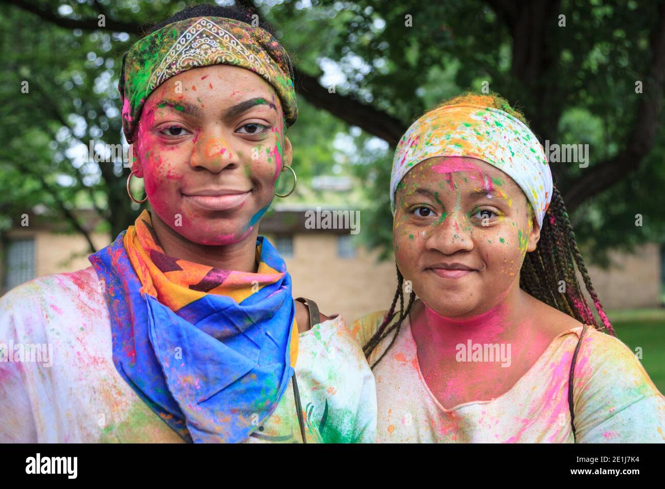 Two female revellers enjoy J'ouvert morning with face paint and colour ...