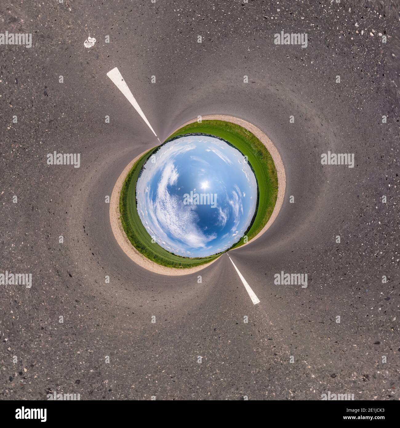 Blue little planet on asphalt road. Inversion of tiny planet ...