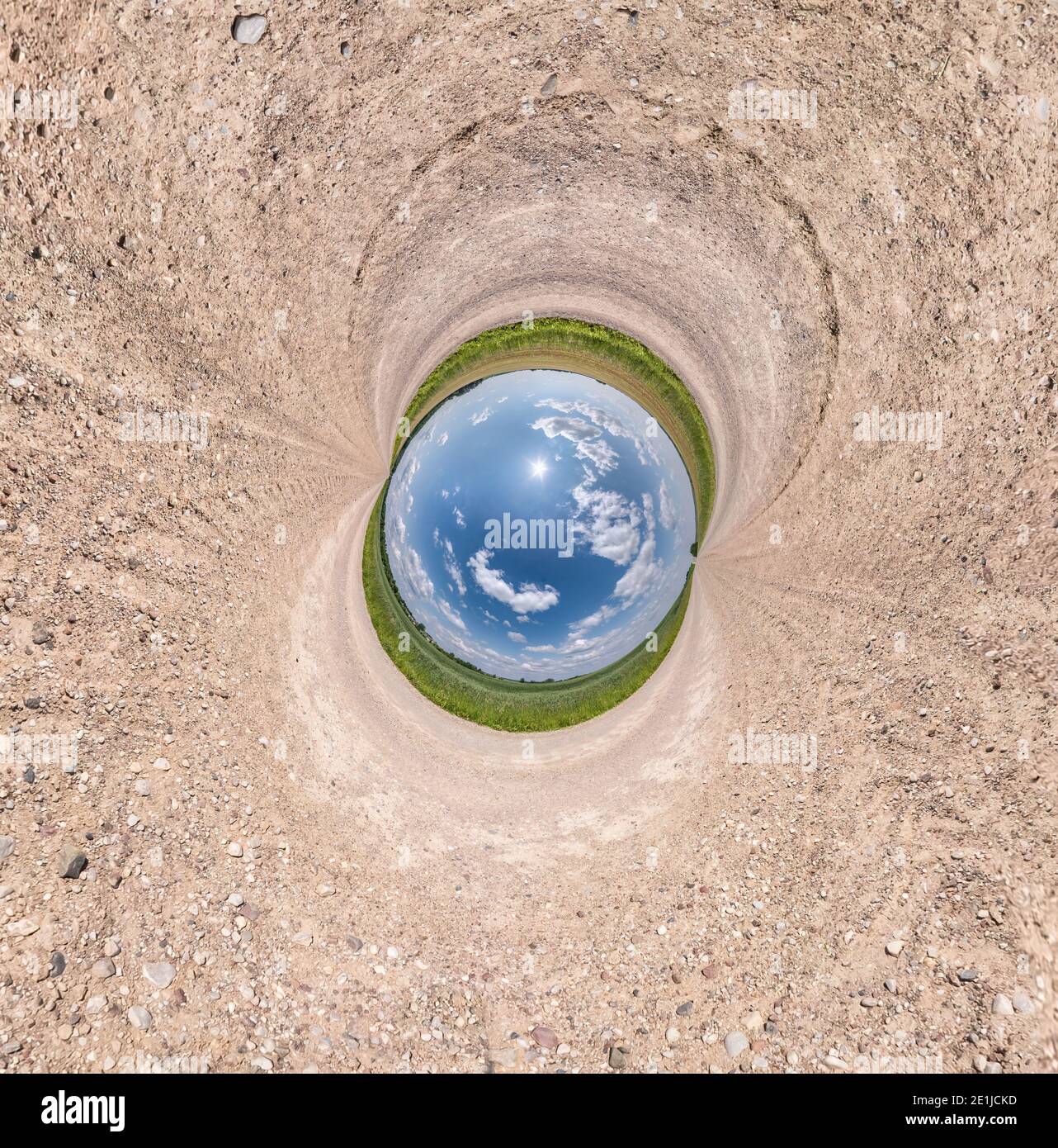 Blue little planet among white sand. Inversion of tiny planet ...