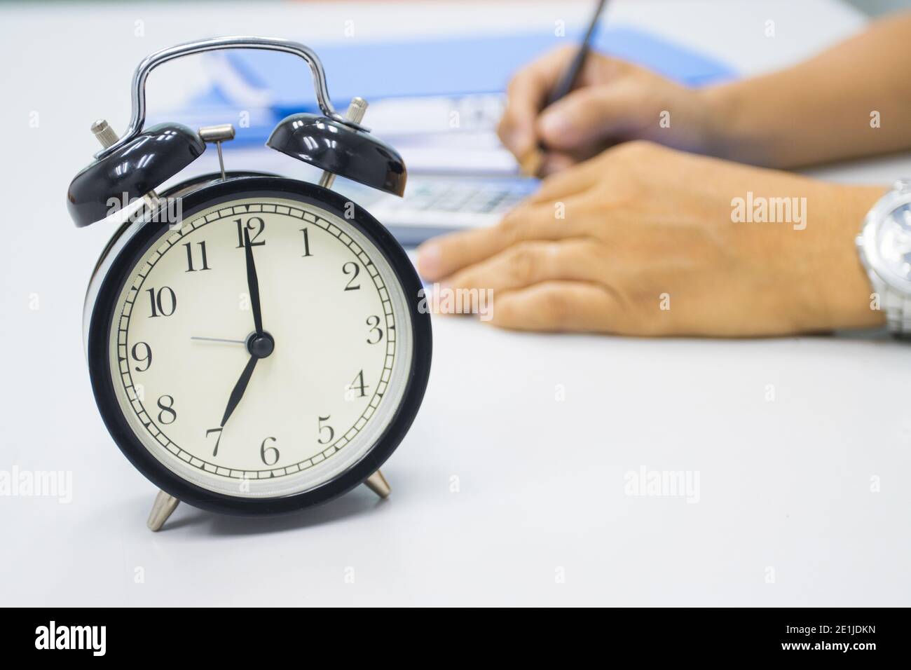 7 AM Clock on work desk in the office Time of businessman working ...