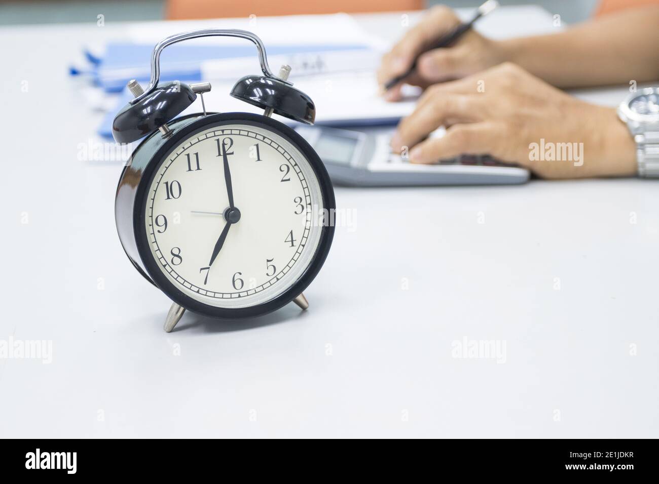 7 AM Clock on work desk in the office Time of businessman working ...