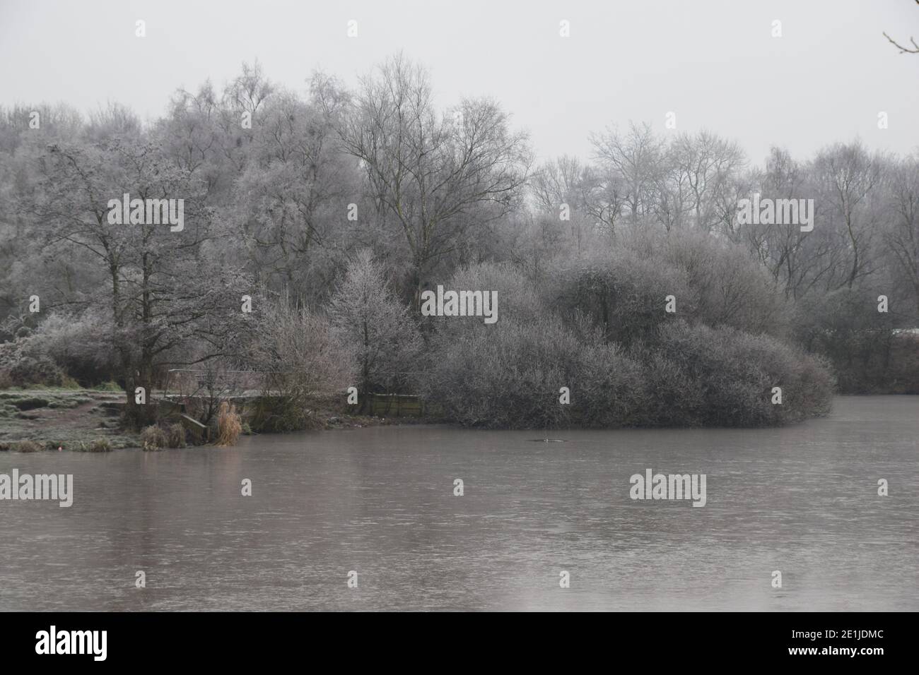 Freezing cold morning at the lakeside with a deep hoar frost coating ...
