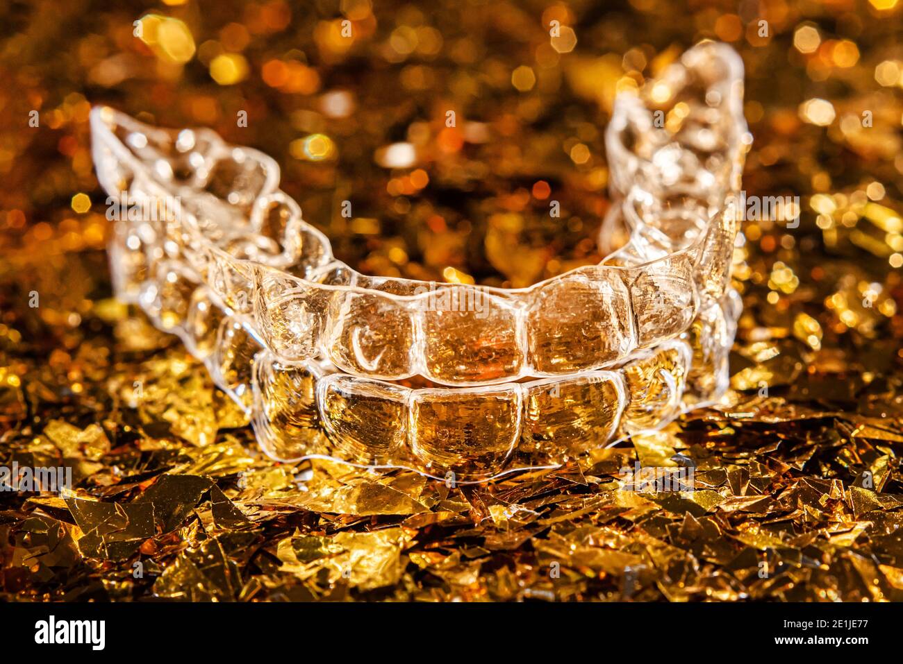 Invisible dental teeth brackets tooth aligners on gold background ...